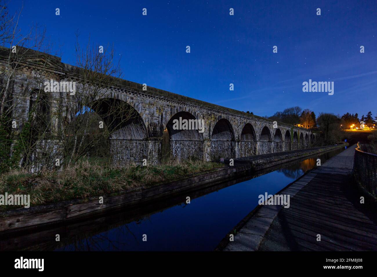 Chirk Aqueduct and railway viaduct stand under a starry sky whilst ...