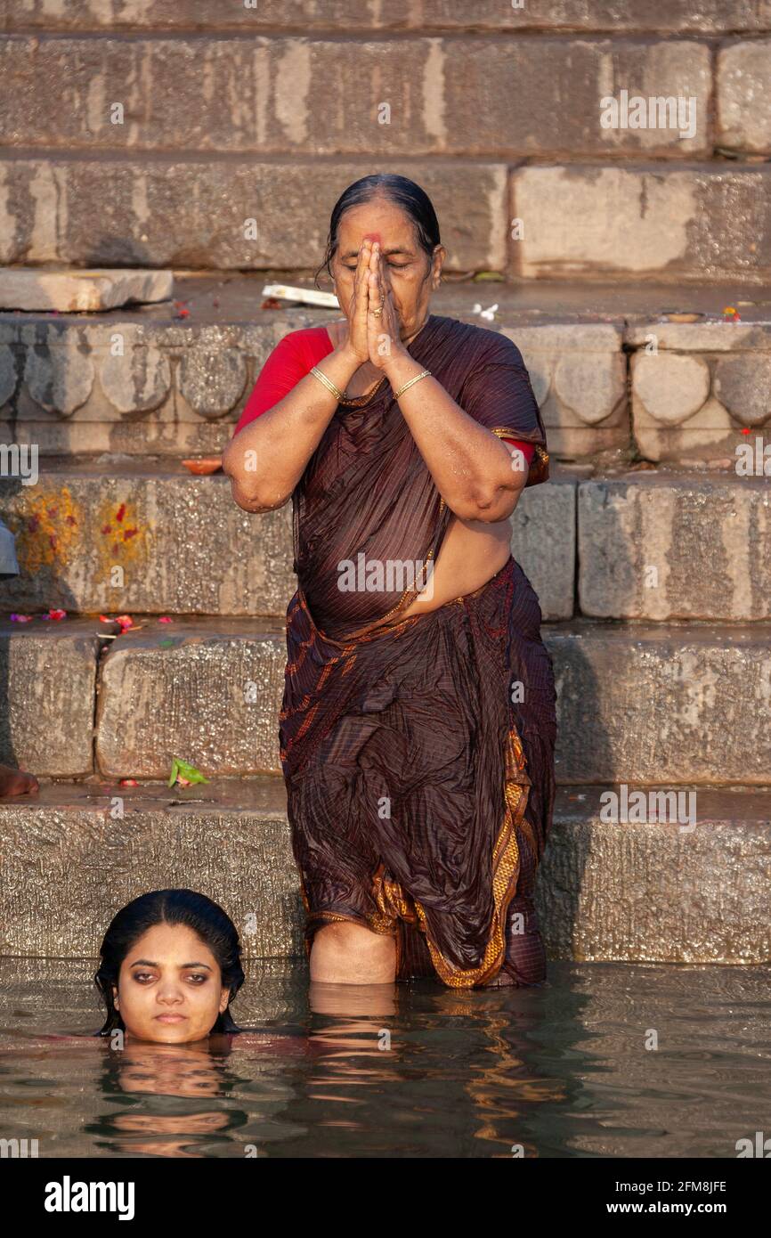 Hindu devotees bathing in the Holy River Ganges at the Hindu Ghats in ...