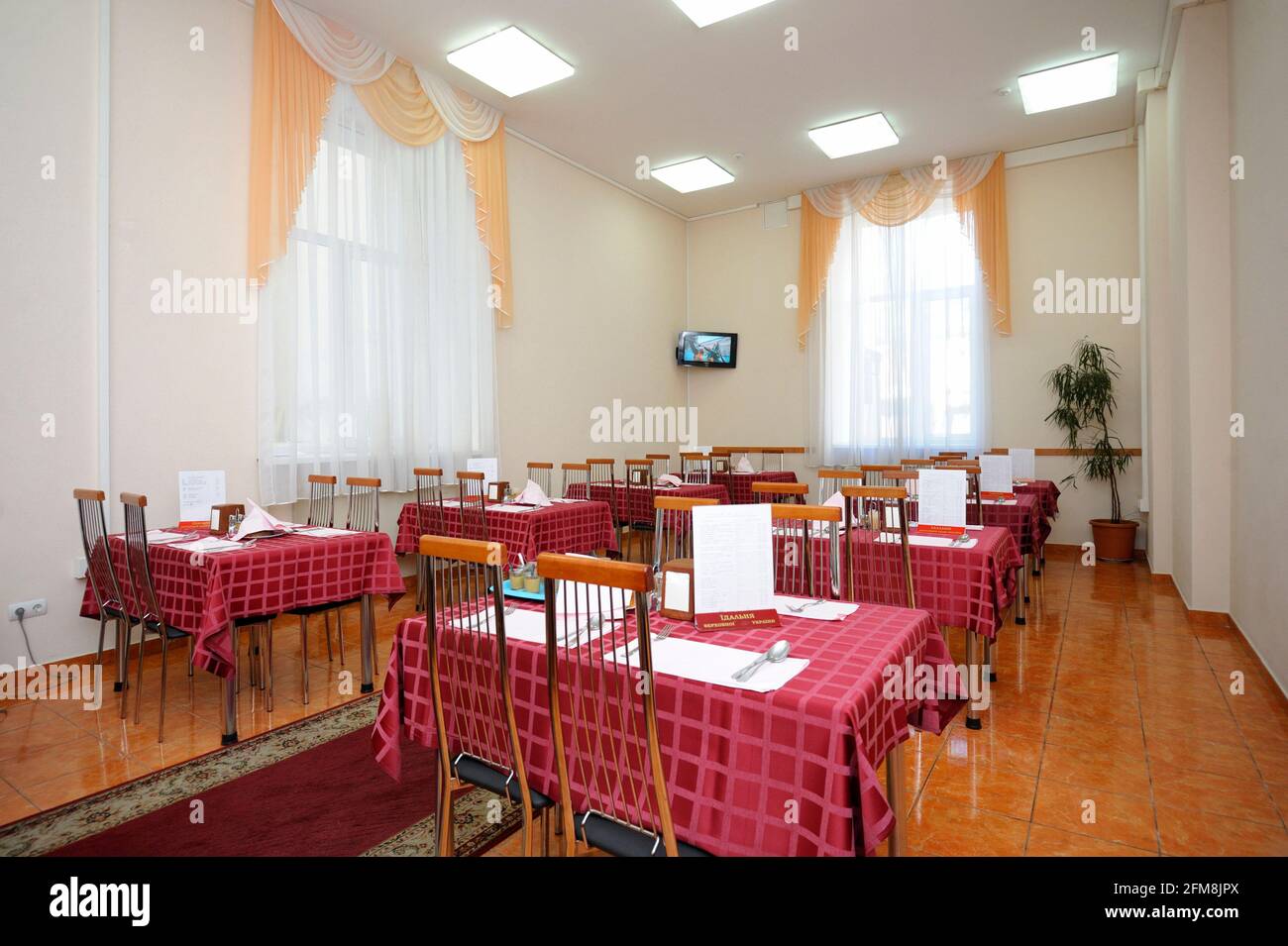 Tables set for lunch in the dining room. Day of opened door for mass ...