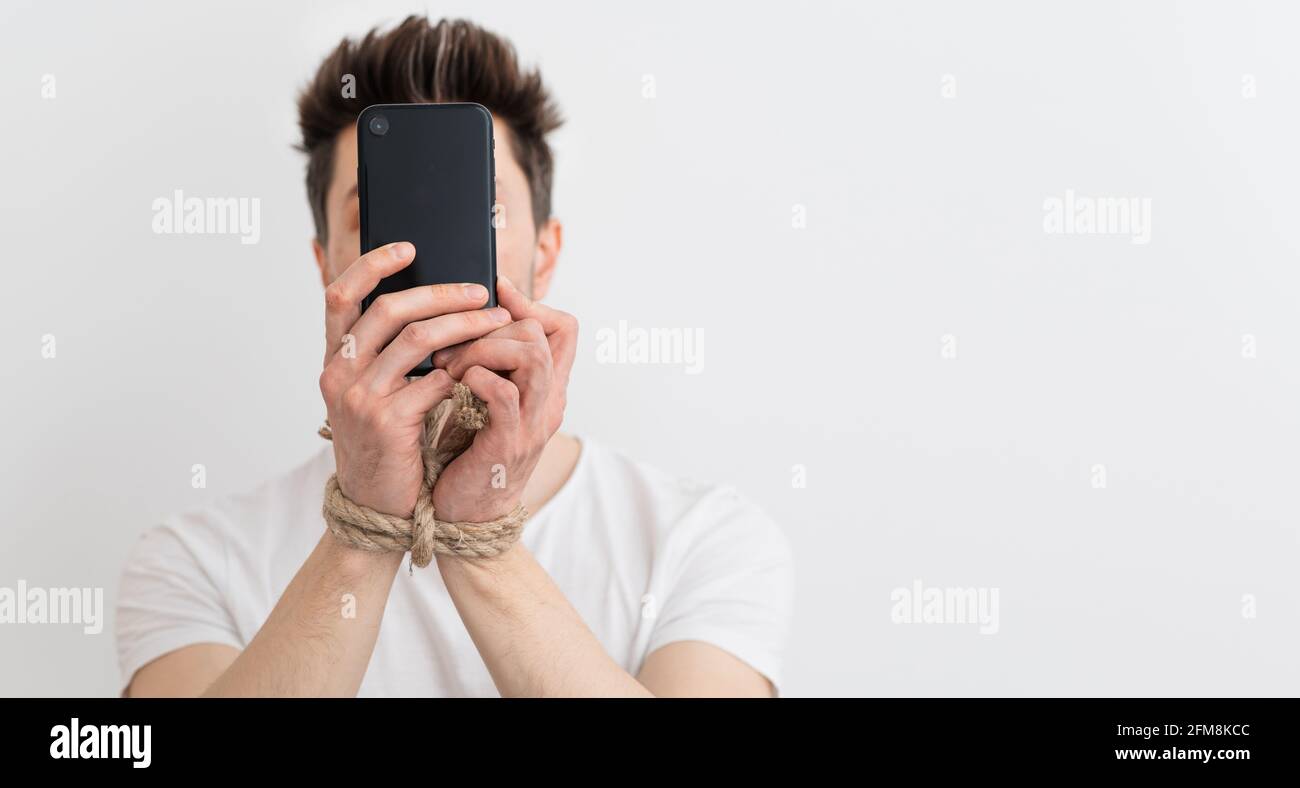 Internet Addiction Or Social Media Addiction Hands Tied With A Rope