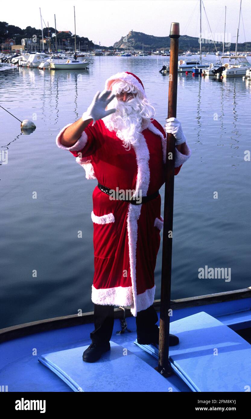 Arrival of Santa Claus by boat at the port of Brusc Stock Photo - Alamy