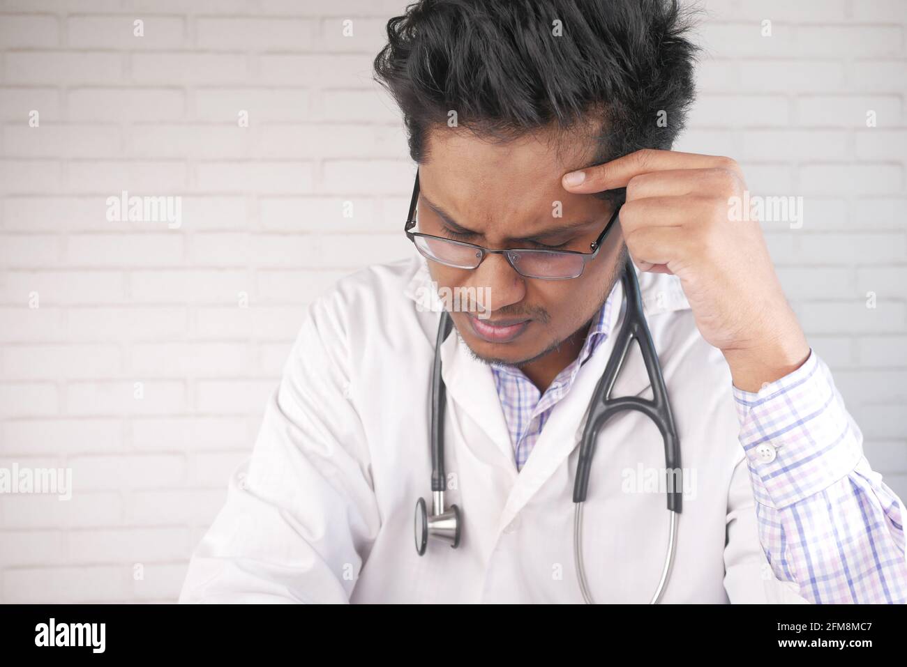 Depressed sad doctor covering face with hands Stock Photo - Alamy