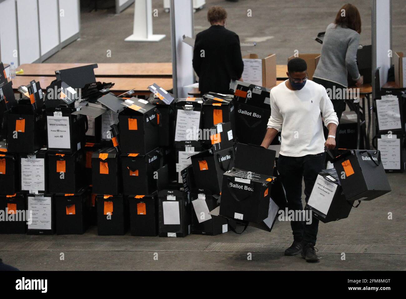 Empty ballot boxes are taken away during the counting for the local ...
