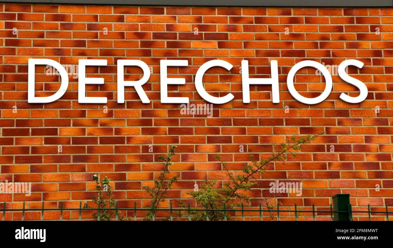 Spanish school sign in large white capital letters on a brick wall in ...