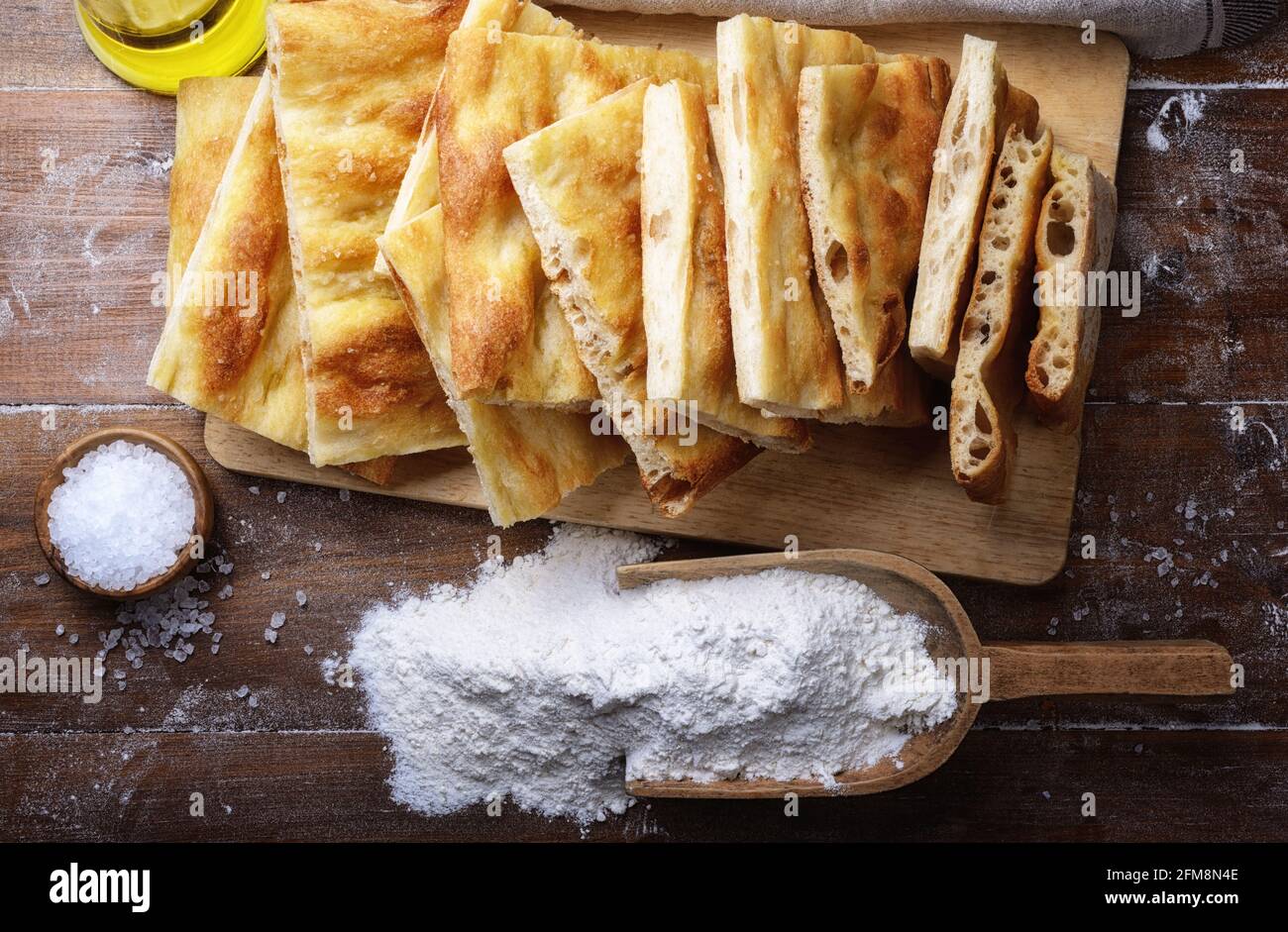 Italian focaccia bread with flour, salt and extra virgin olive oil on ...