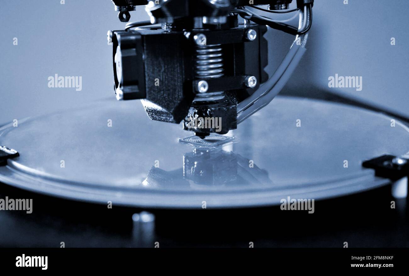 Modern 3D printer printing figure. Automatic three dimensional 3d ...