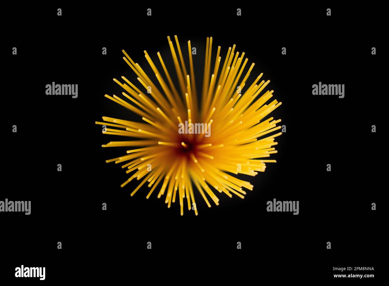 Spiky ball made with spaghetti on a plain black background - pasta art ...