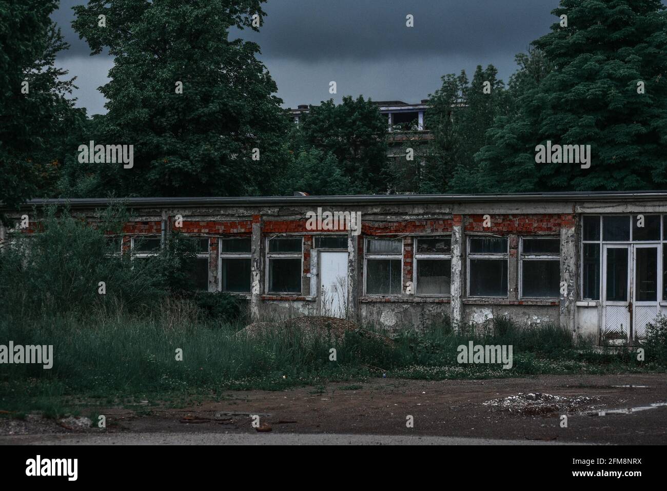 Abandoned one-story building with doors and windows Stock Photo - Alamy