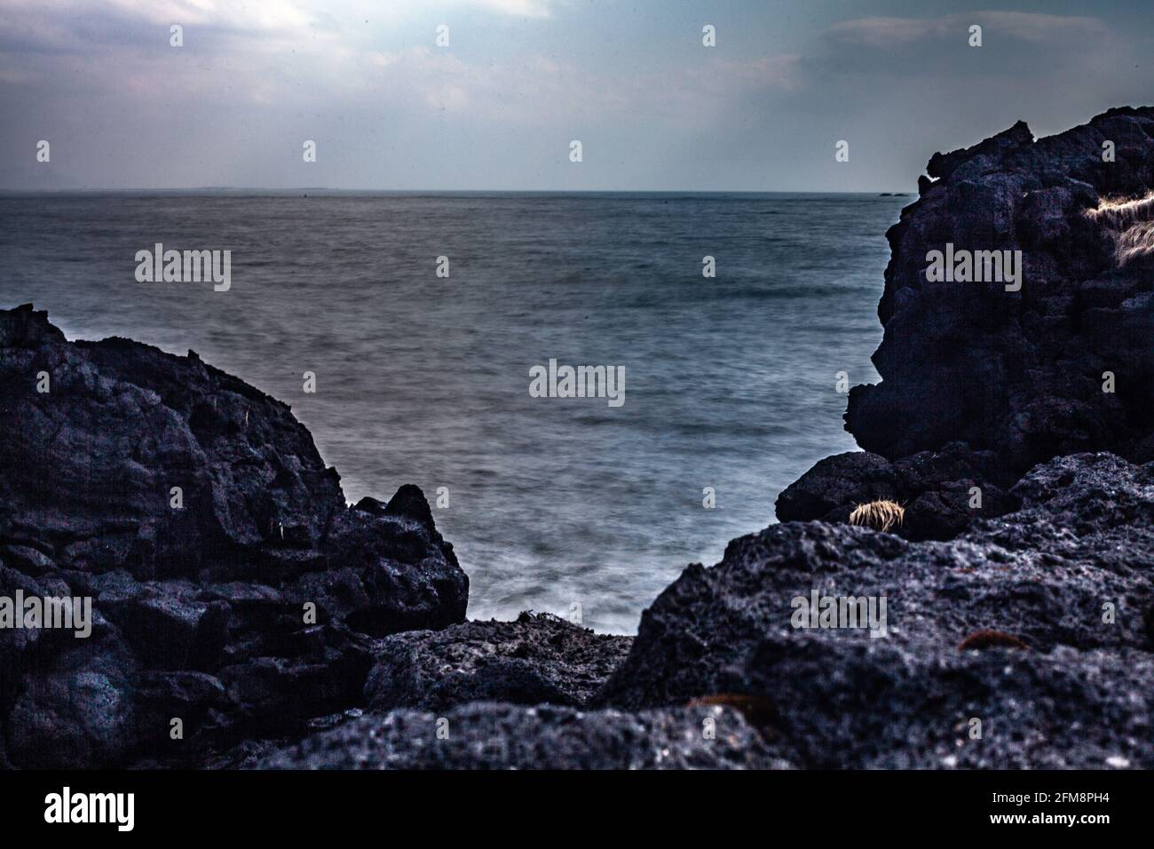 Grayscale shot of rocky beach Stock Photo - Alamy