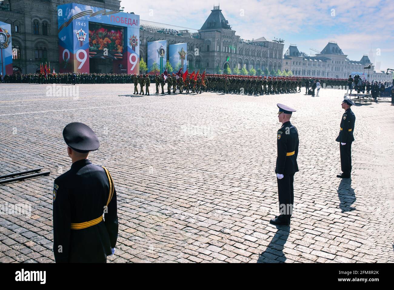People in military uniforms walk along Red Square in Moscow. Victory ...
