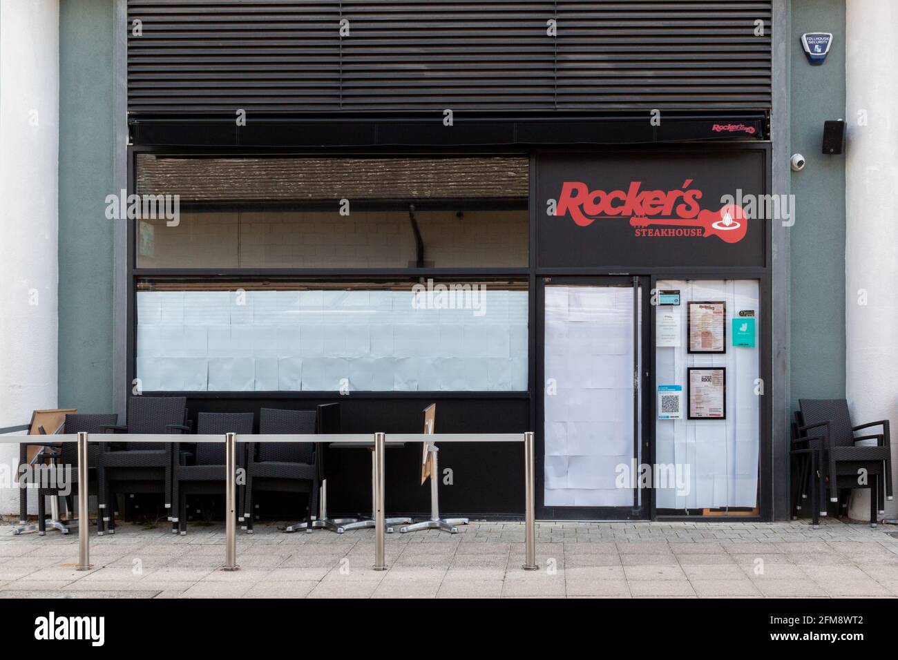 An exterior view of a closed down Rocker's restaurant. The windows and ...