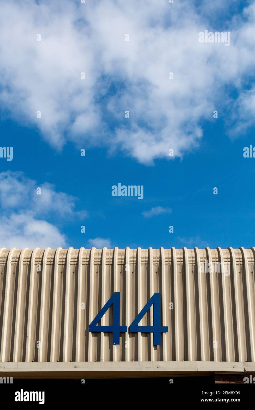 A large blue number 44 on a striped background with blue skies Stock ...