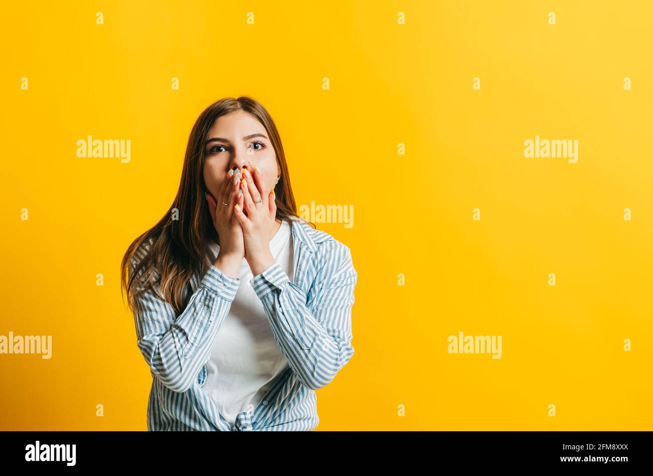 Portrait of excited young woman surprised by something expresses shock ...