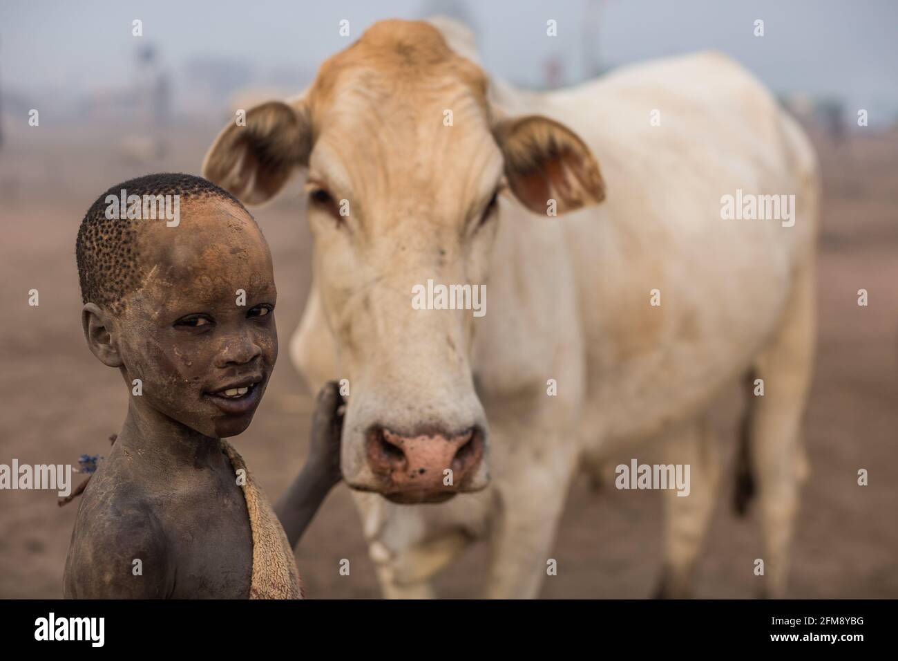 A young Mundari boy photographed posing with his cow. TERAKEKA, SOUTH SUDAN: MEET THE cattle ...