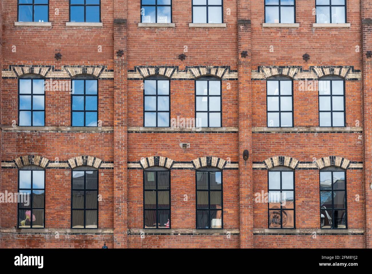 A pattern of windows in a heritage red-brick colonial-style ...