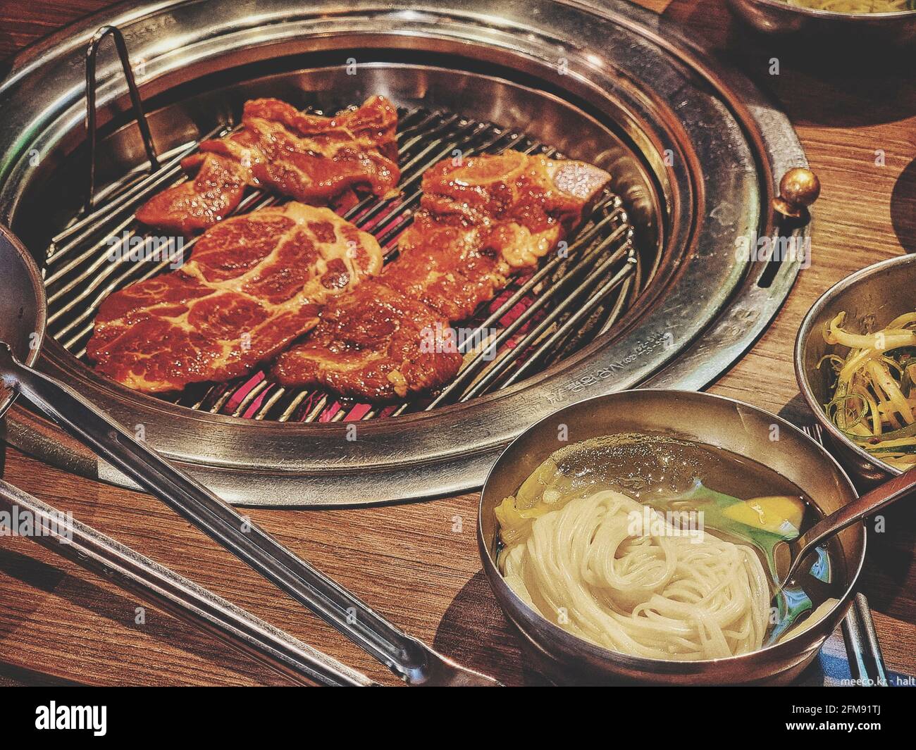 Bulgogi is marinated slices of beef grilled on a barbecue Stock Photo ...