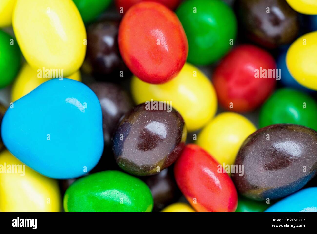 Colorful dragees, close-up on a white background. Chocolate candies in ...