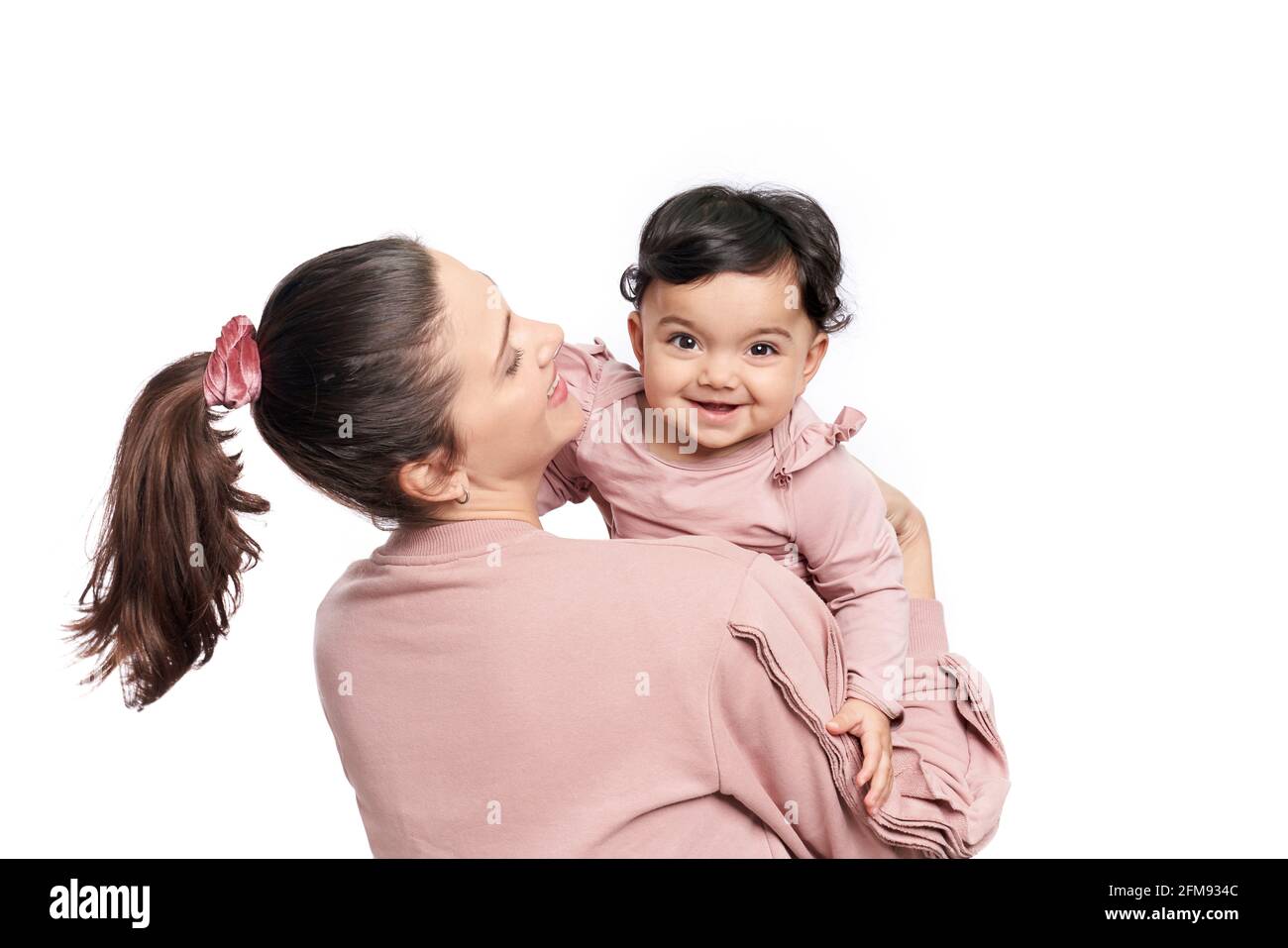 Back view of young mother having fun with daughter, isolated on white ...