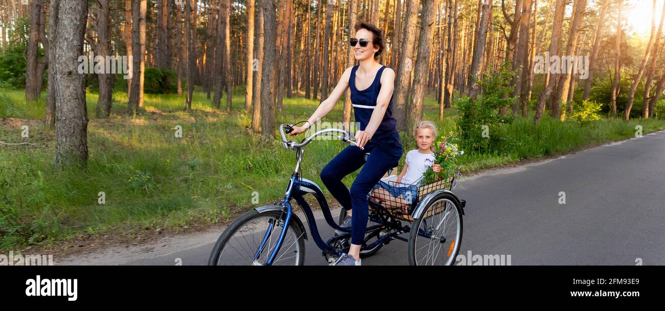 Young woman riding tricycle hi-res stock photography and images - Alamy