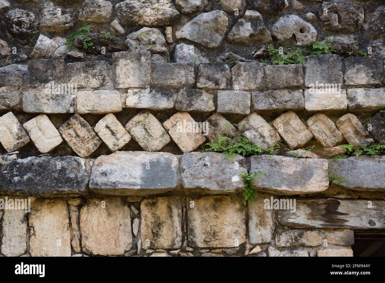 Close-up view of tilted frieze stones at ball court Mayan ruins of Ek ...
