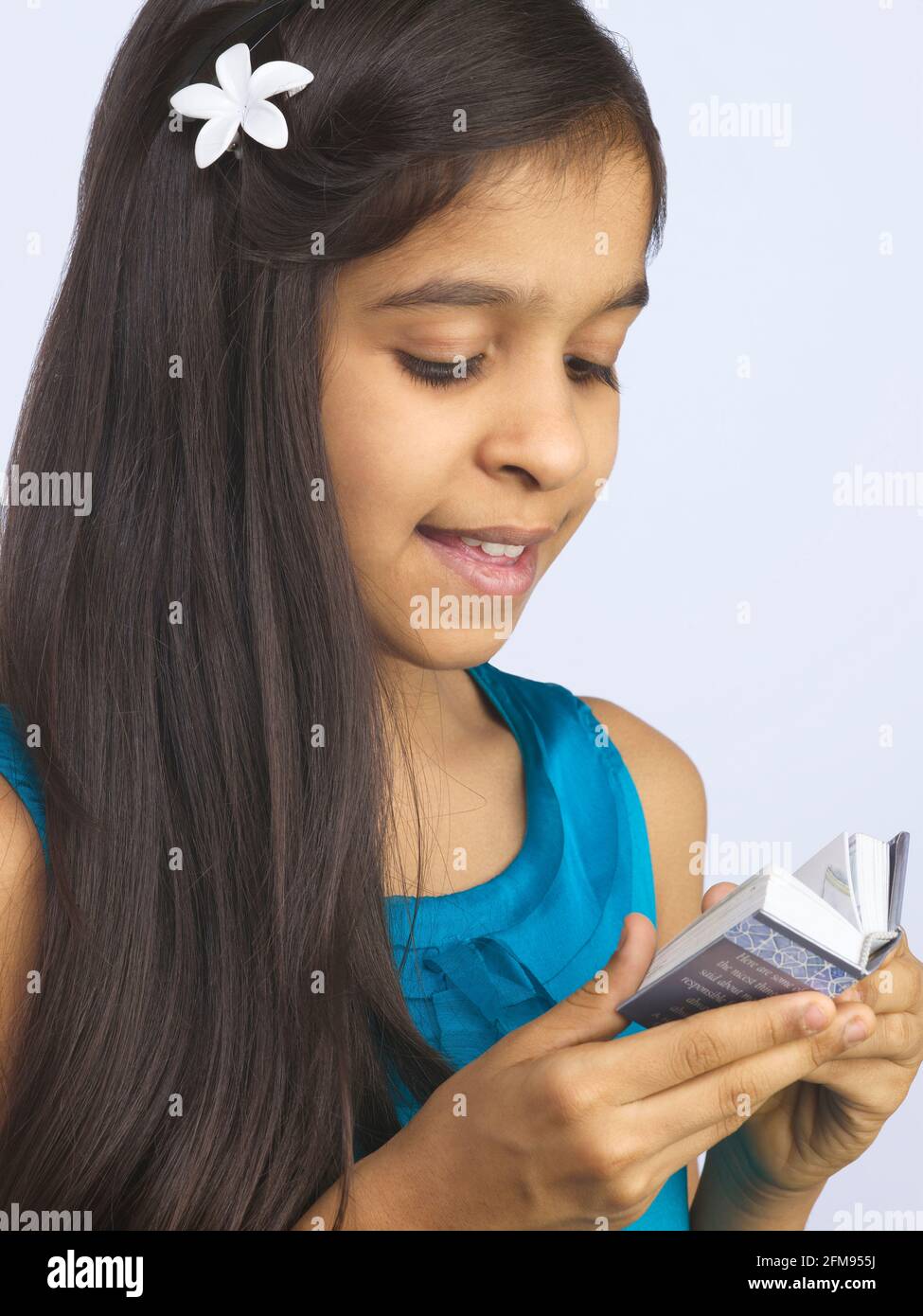 YOUNG GIRL READING A BOOK. AGAINST A PLAIN BACKGROUND Stock Photo - Alamy