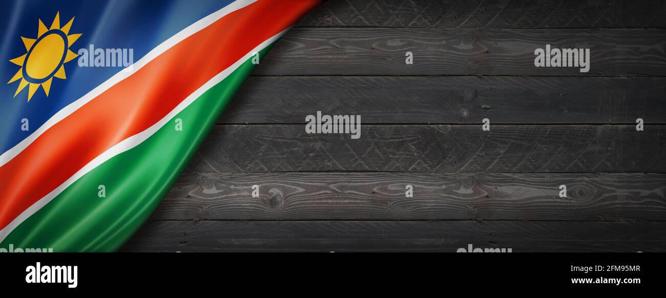 Namibia flag on black wood wall. Horizontal panoramic banner Stock ...