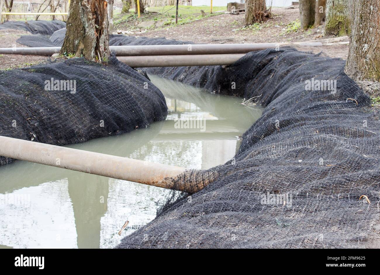 banks of the stream are covered with a special mesh protecting from ...