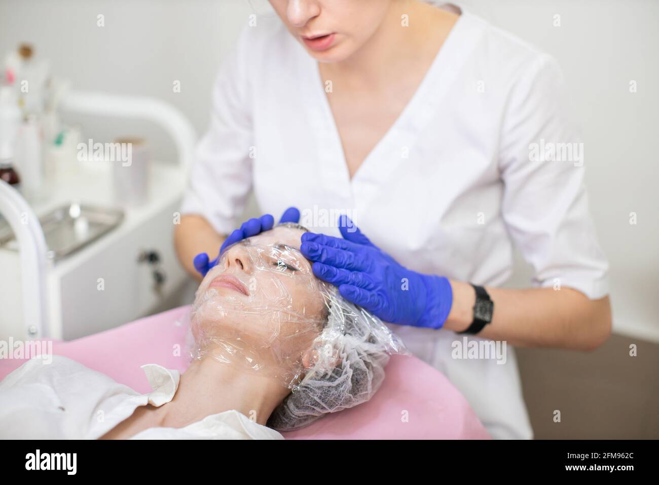 Close up of professional doctor dermatologist in blue rubber gloves ...