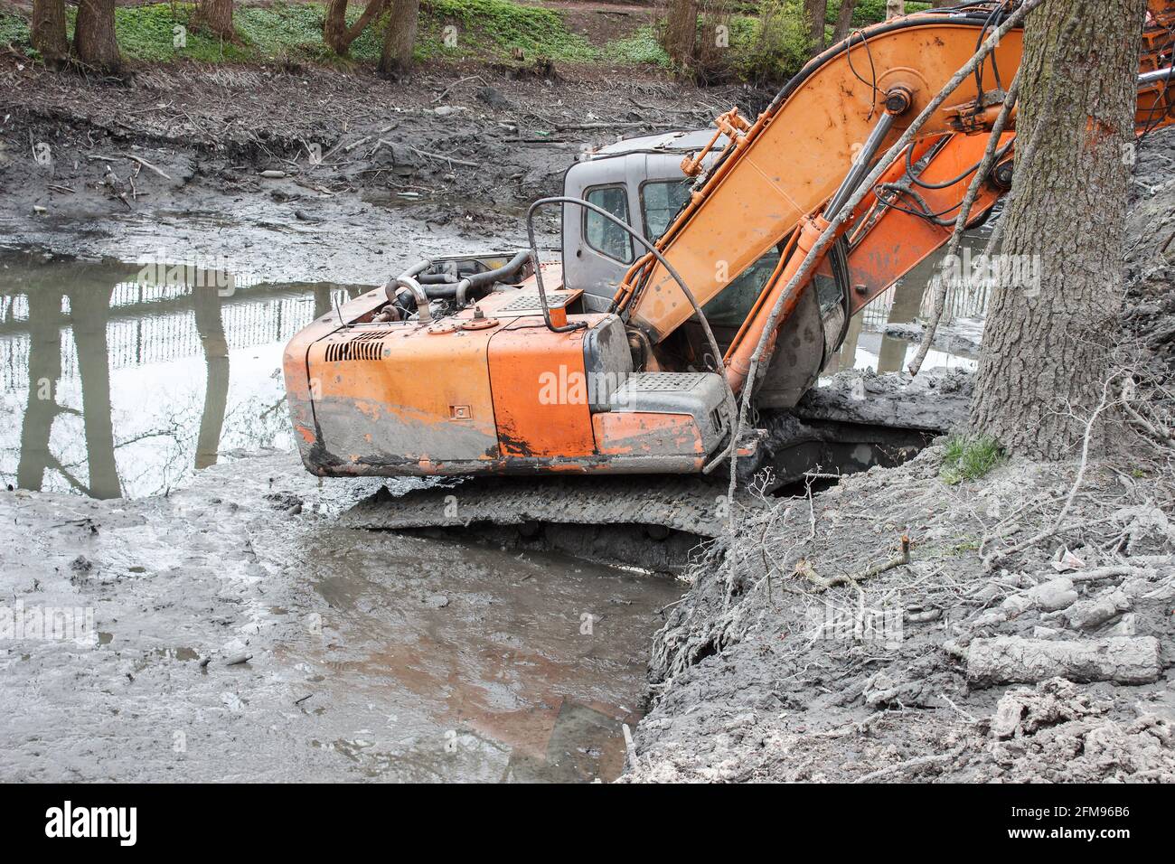 Excavator digger machine at canal construction site hi-res stock ...
