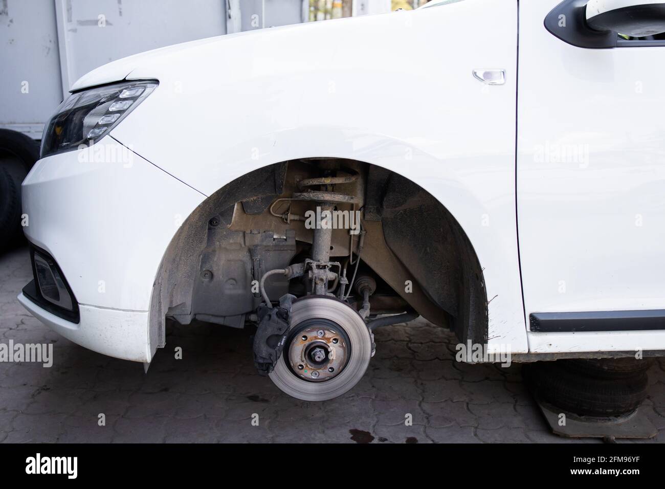 Car without a wheel. Removed front wheel, close up view photo Stock ...