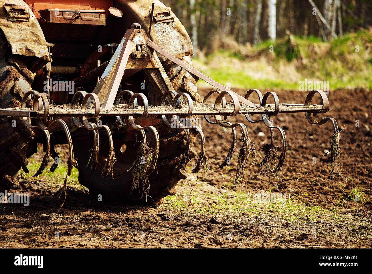 plow tractor plows the land for planting agricultural plants. the ...