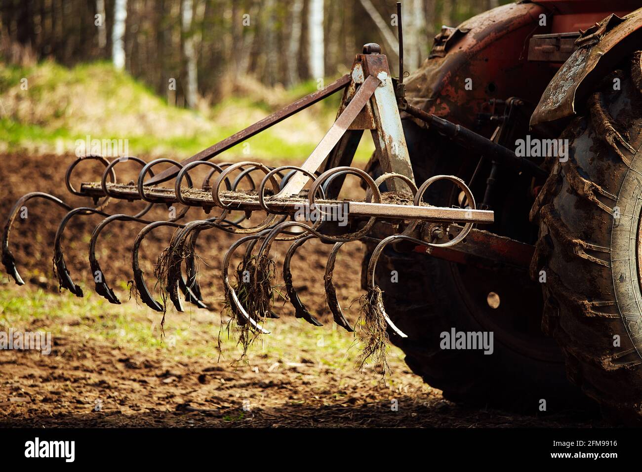 plow tractor plows the land for planting agricultural plants. the ...