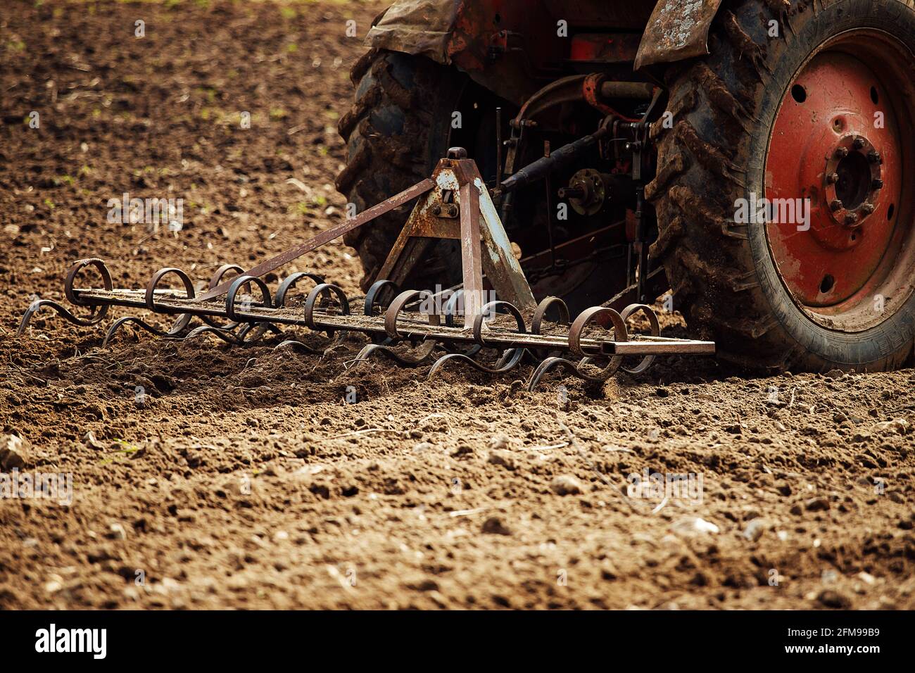 plow tractor plows the land for planting agricultural plants. the ...