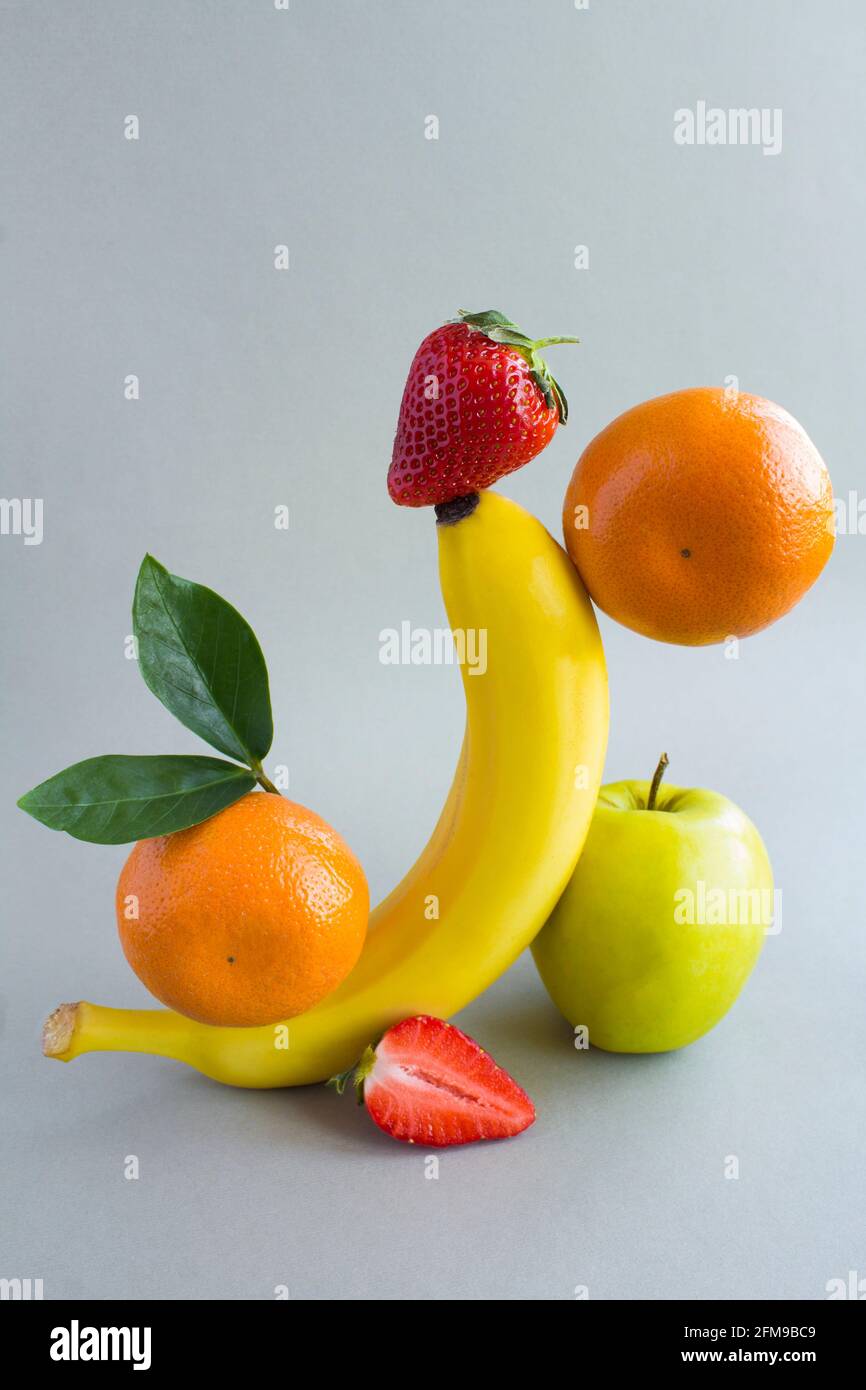 Pyramid of fruit in balance on the gray background. Close-up Stock ...