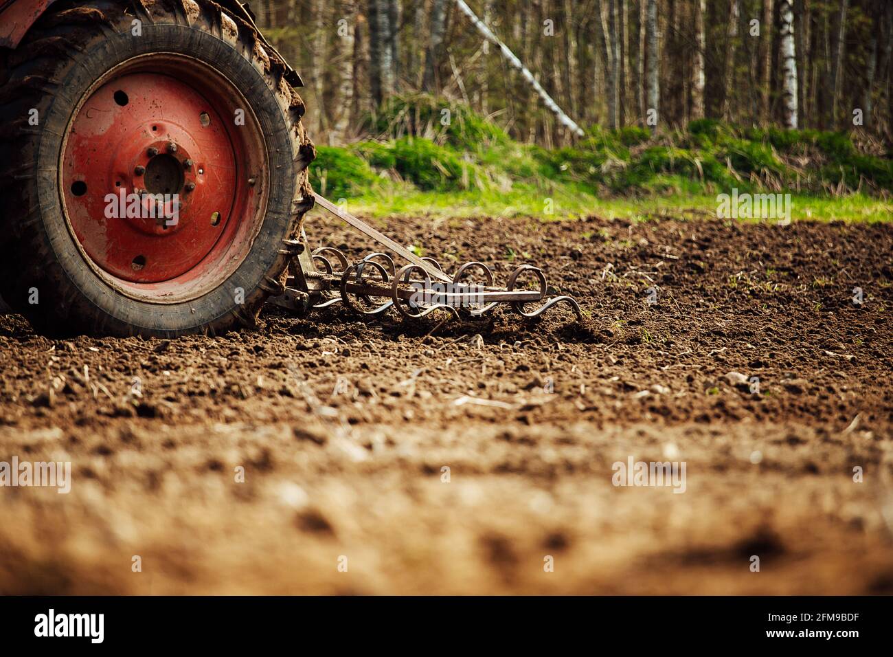 a tractor plows a field. preparation of agricultural land for planting ...