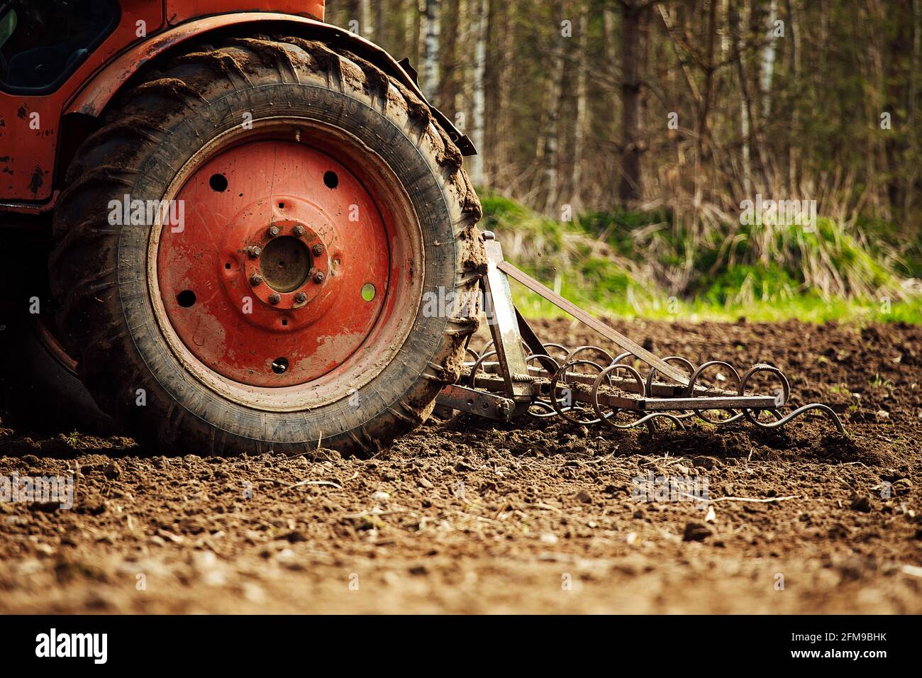 a tractor plows a field. preparation of agricultural land for planting ...