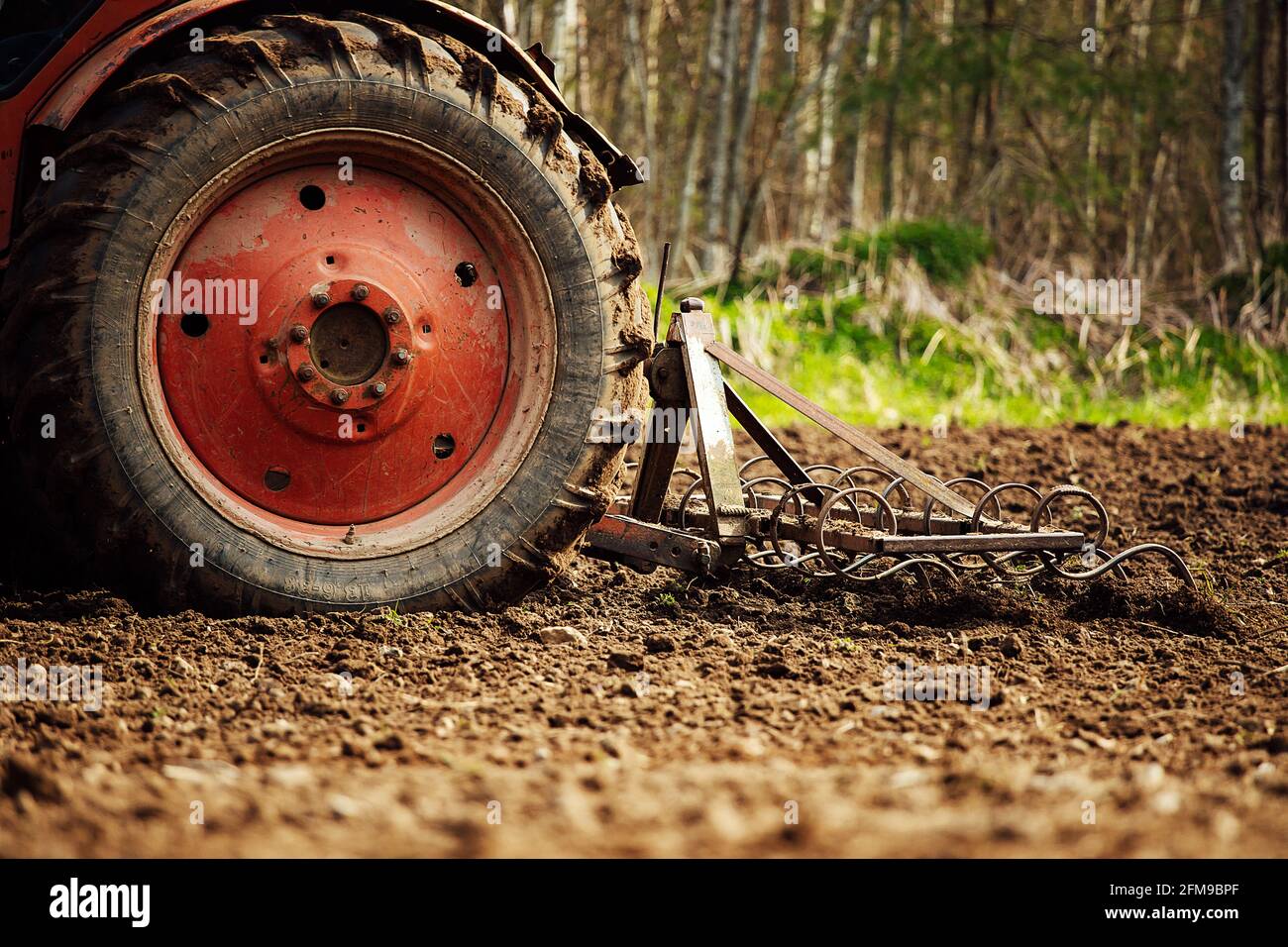 a tractor plows a field. preparation of agricultural land for planting ...