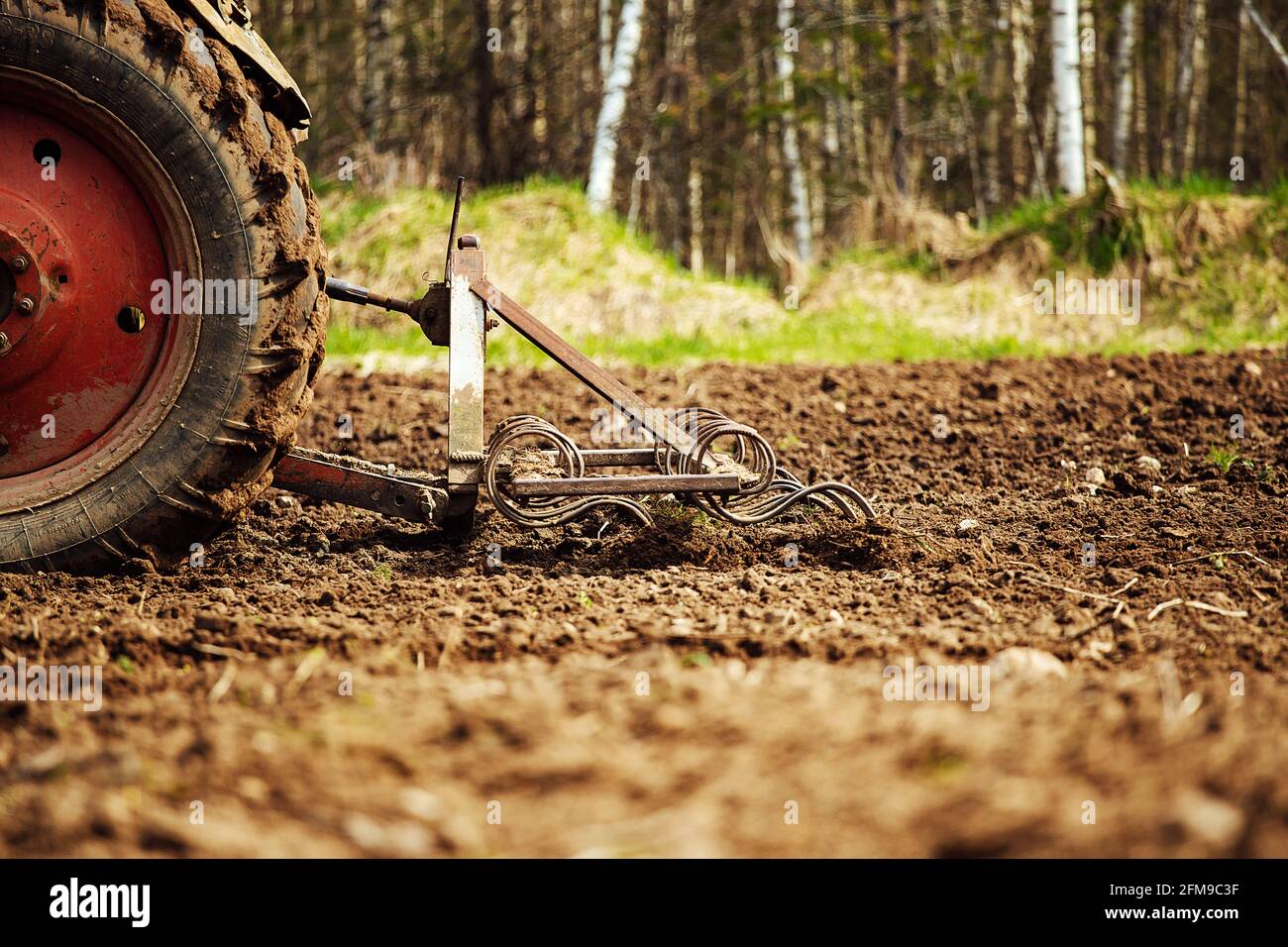 plow tractor plows the land for planting agricultural plants. the ...