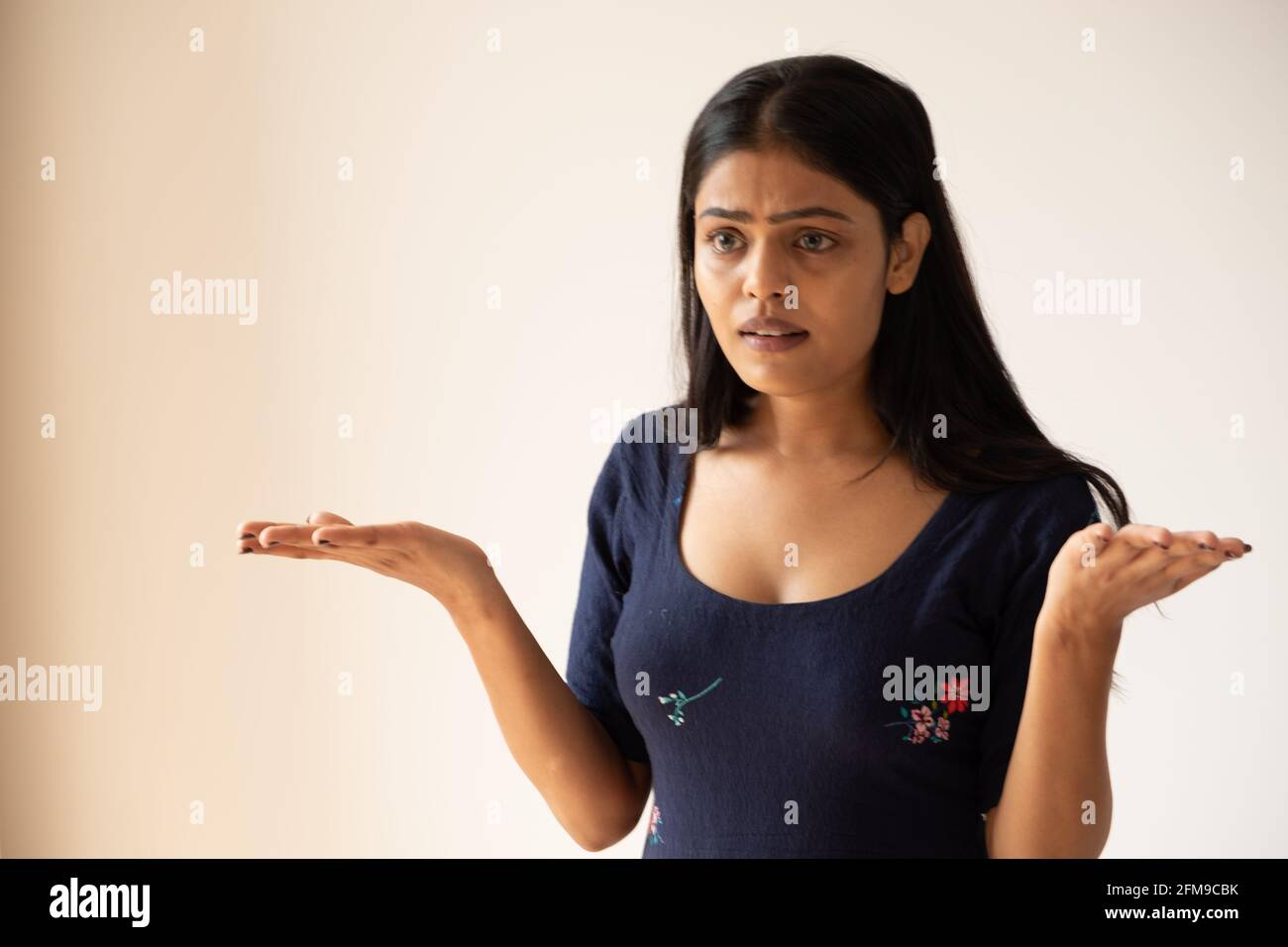Closeup shot of a disappointed Asian girl isolated on a white ...