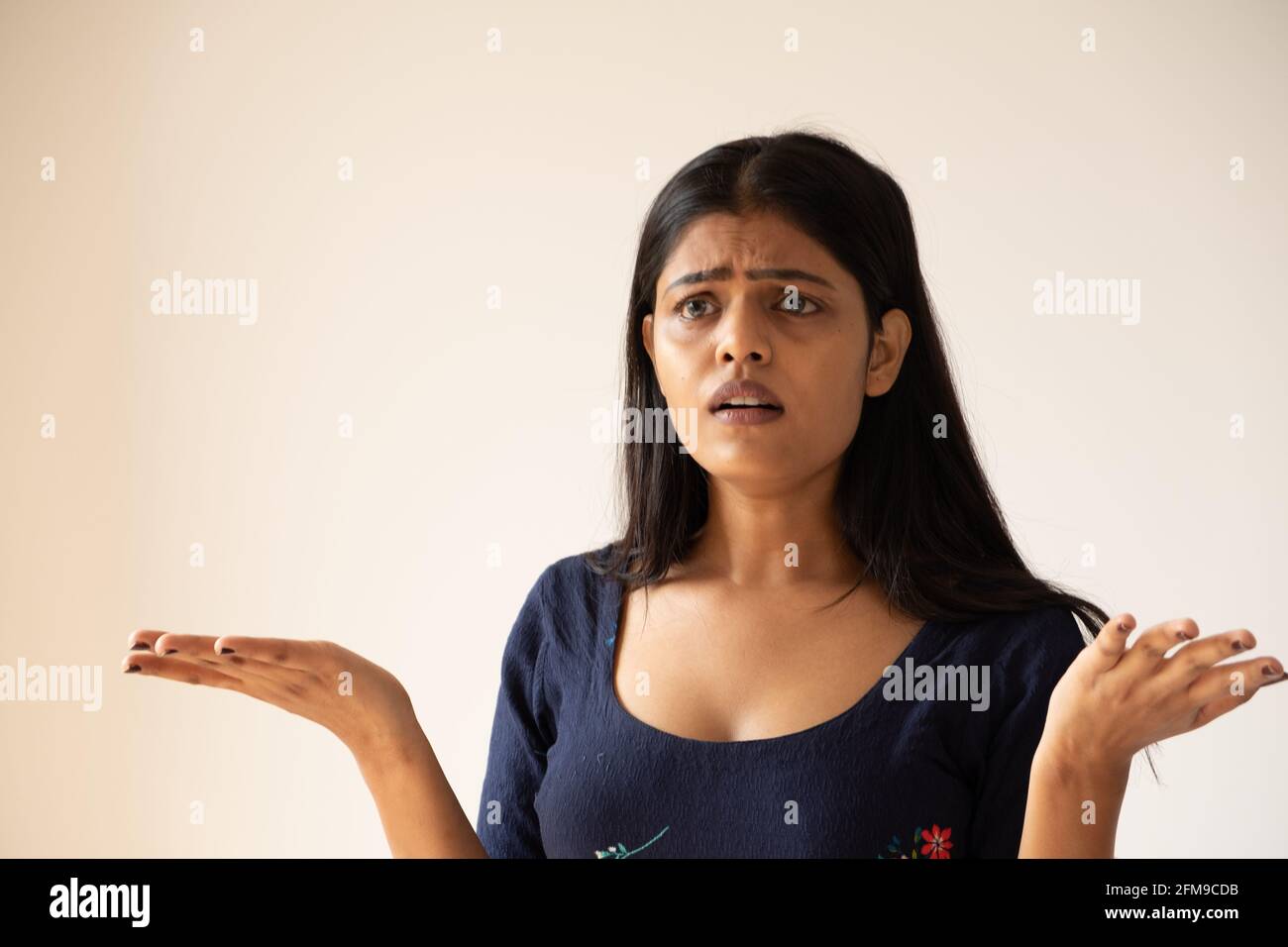 Closeup shot of a disappointed Asian girl isolated on a white ...