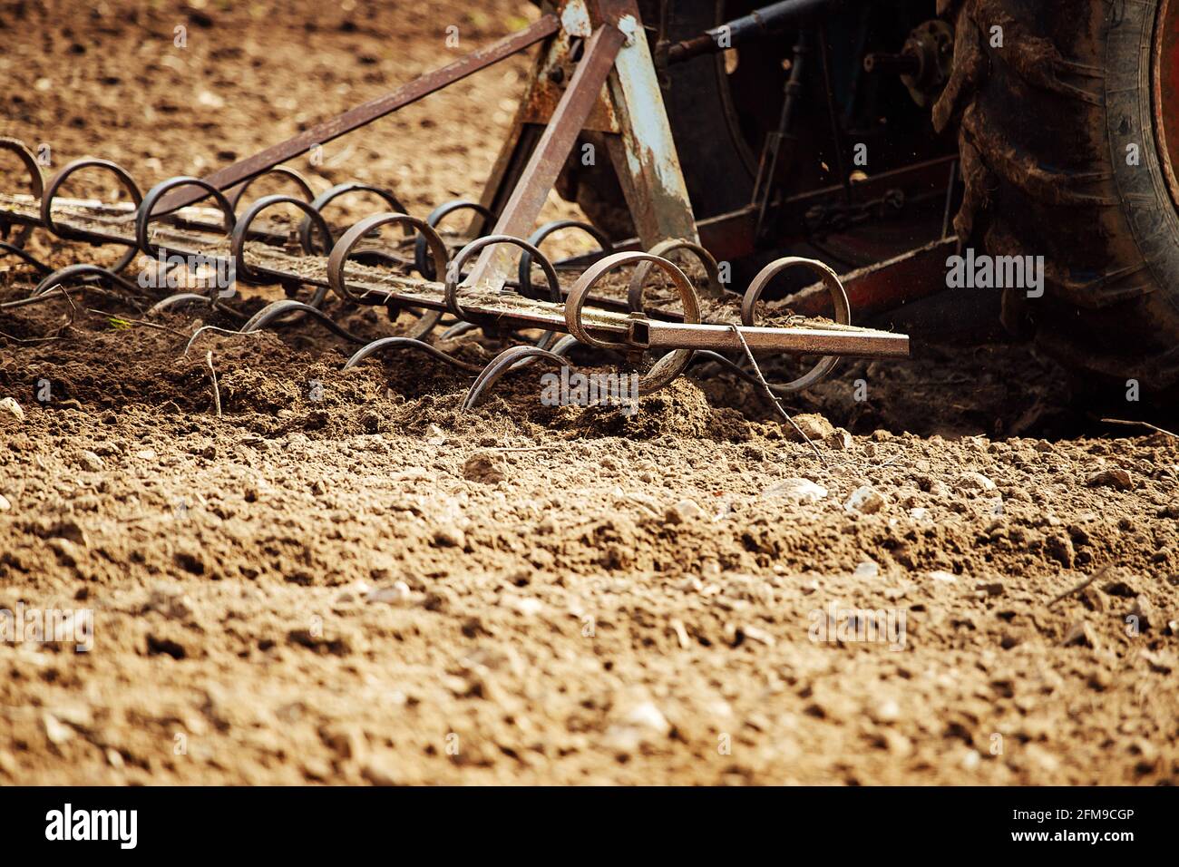 plow tractor plows the land for planting agricultural plants. the ...