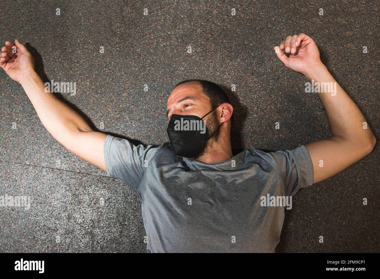 Man lying on the floor very tired after a workout in a gym Stock Photo ...