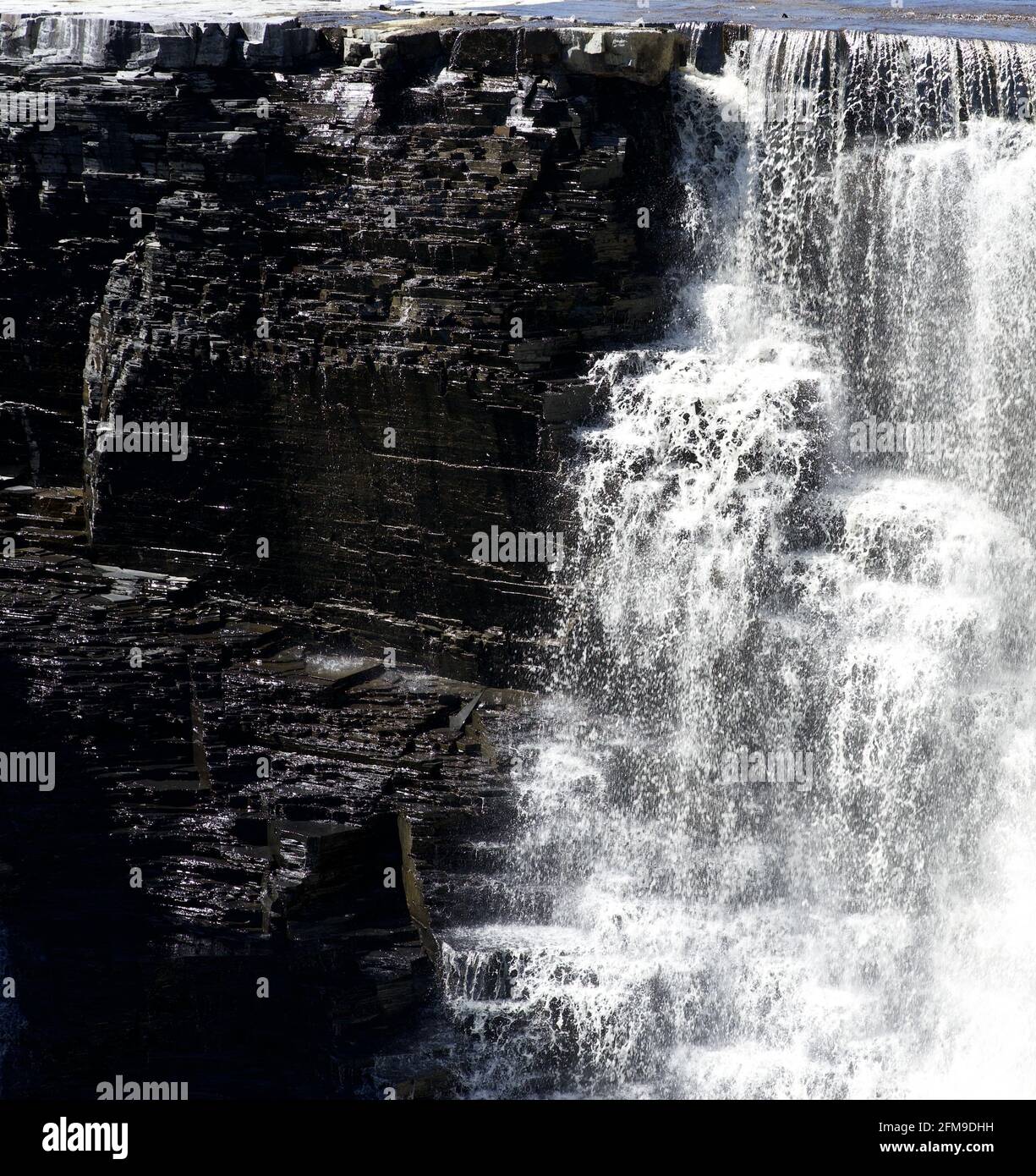 Vertical of a waterfall over cliff layers - perfect for background ...