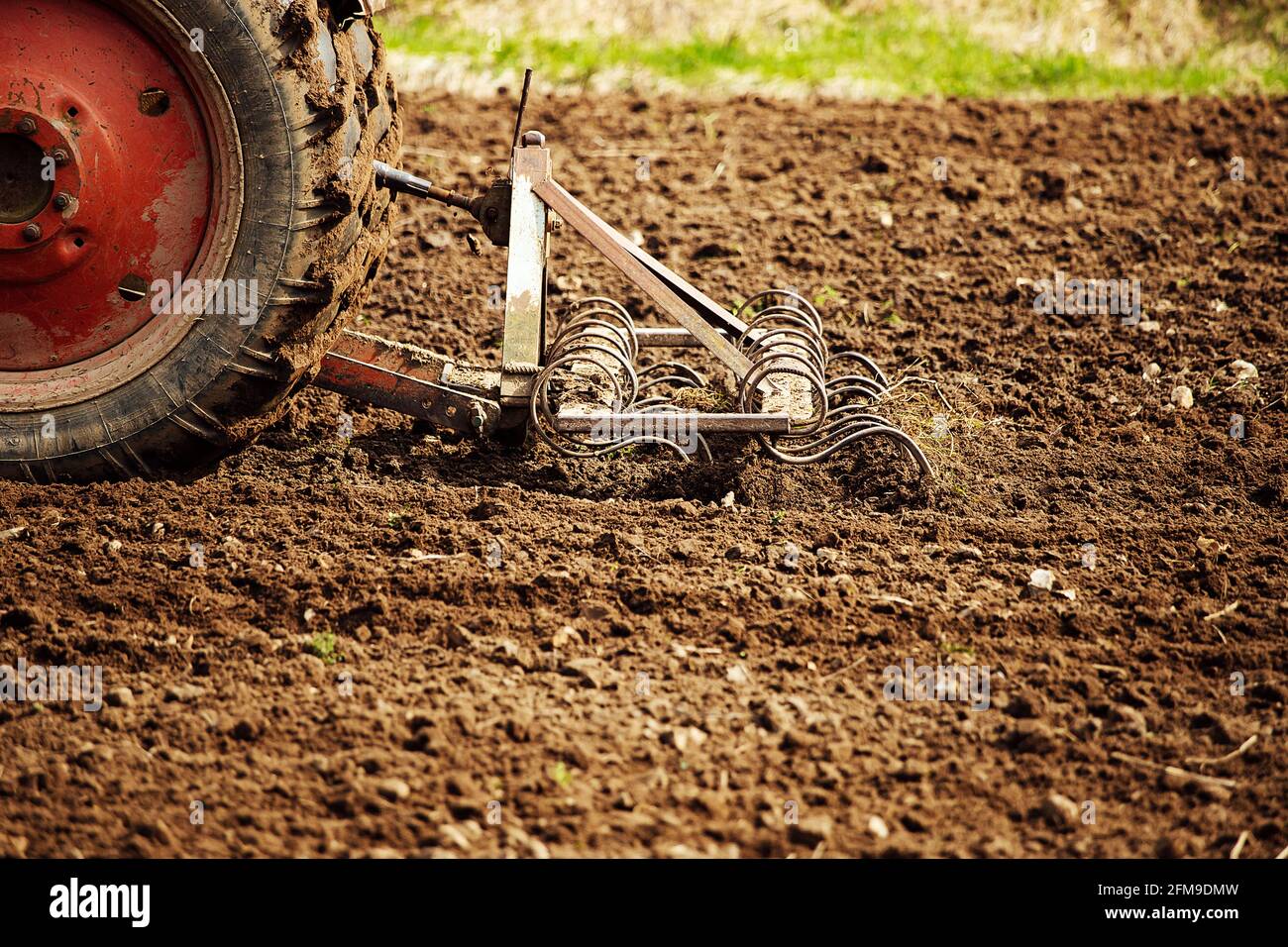 a tractor plows a field. preparation of agricultural land for planting ...