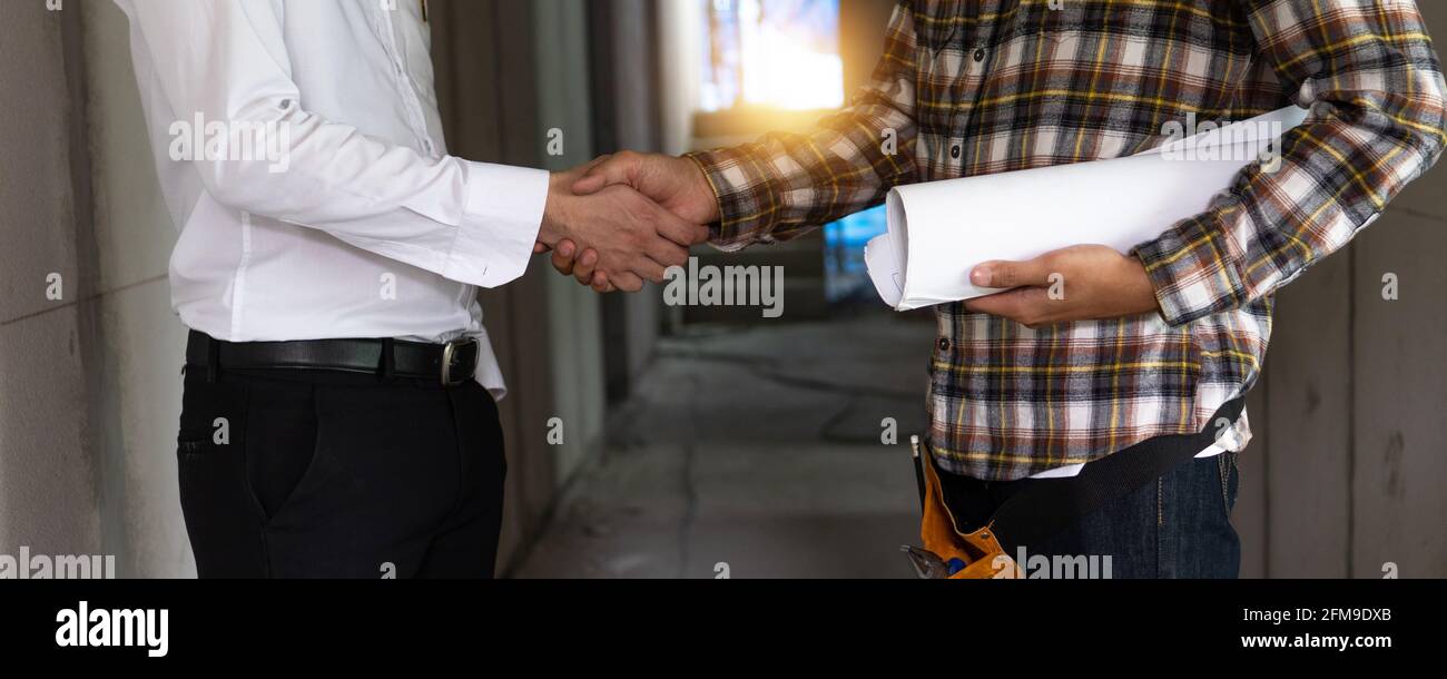 Building contractor shake hand with engineer or foreman after ...