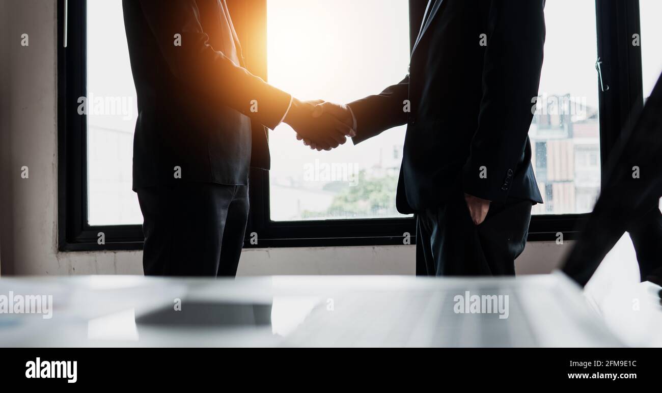 Successful negotiation and shake hand after success in sign business ...