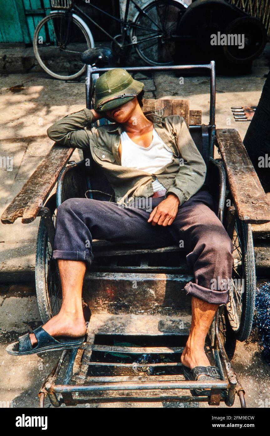 Breaks must be! Rickshaw driver, his military helmet pulled over his ...