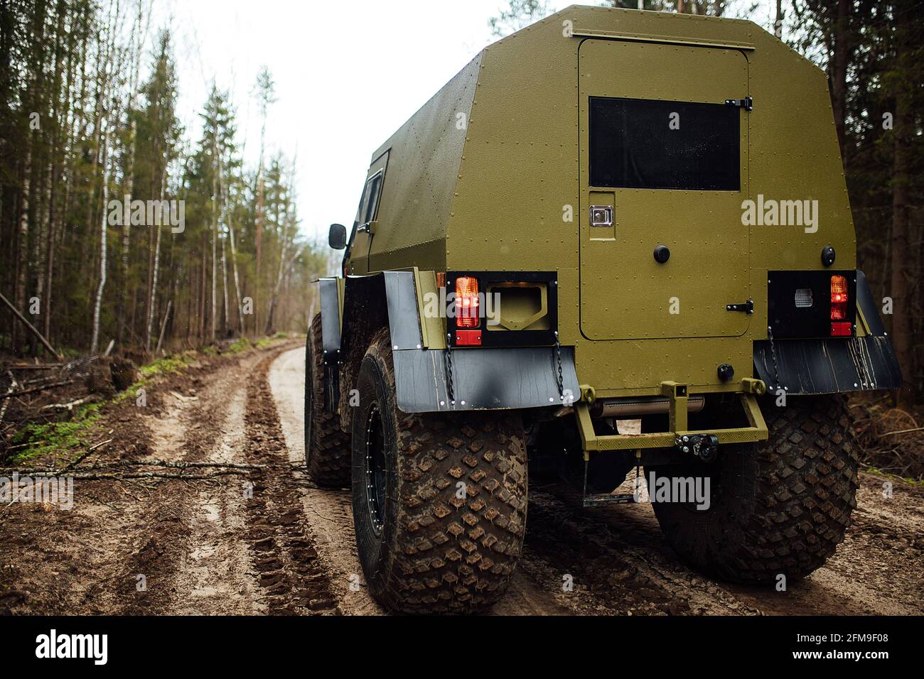 a four-wheel drive all-terrain vehicle drives through the forest ...