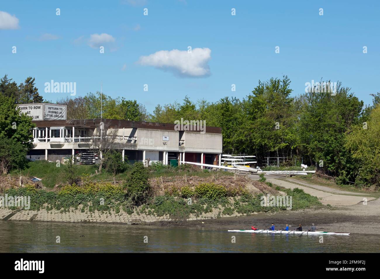 rowers on the river thames pass the thames tradesmen's rowing club at ...