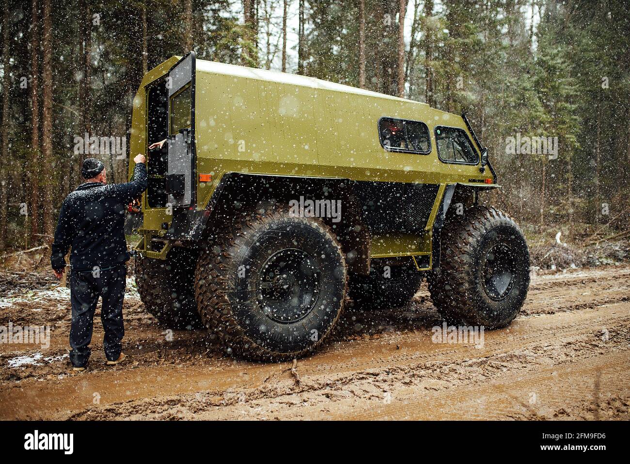 a four-wheel drive all-terrain vehicle drives through the forest ...